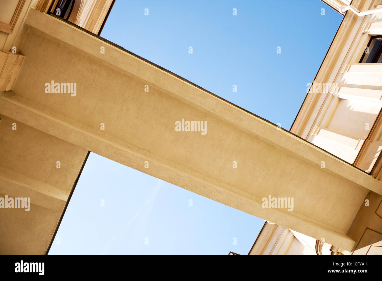 Yellow building detail and a sky Stock Photo - Alamy