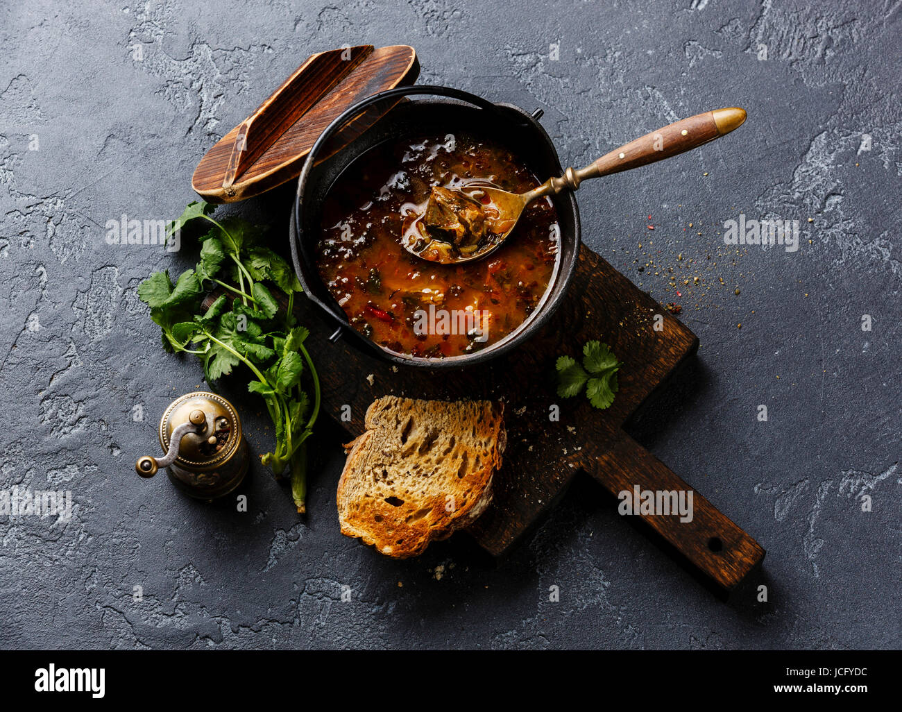 Traditional Georgian soup Kharcho with meat and rice on dark background ...