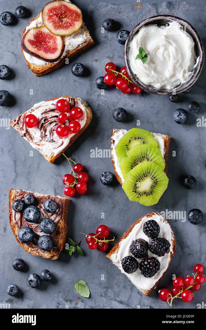 Variety of dessert sandwiches with berries and cream cheese and ...