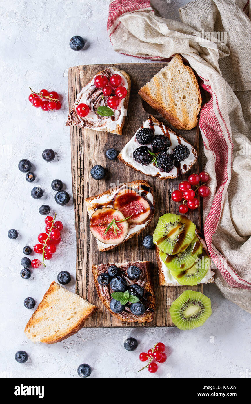 Variety of dessert sandwiches with berries and cream cheese and ...