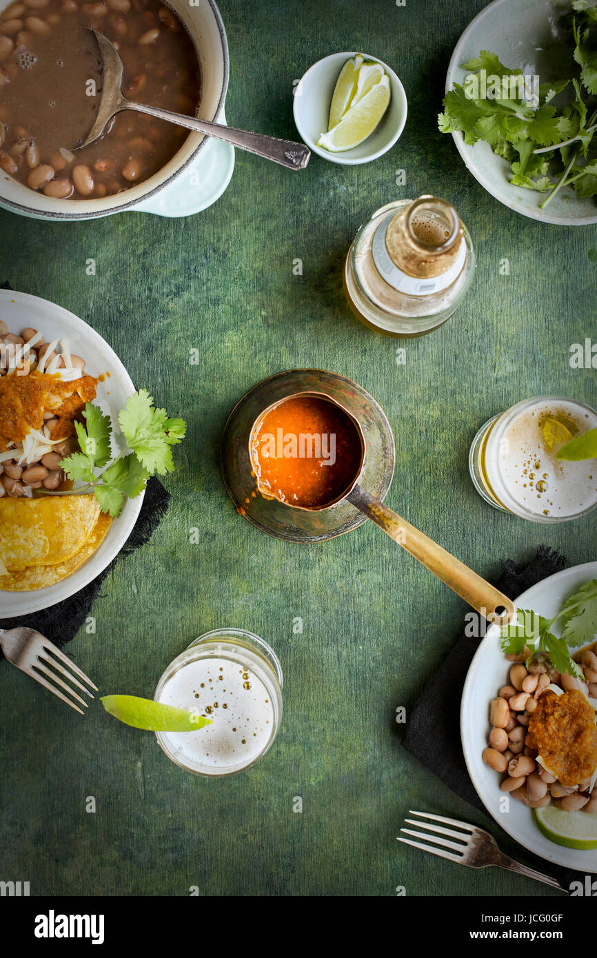 Ranchero Sauce in a vintage copper ladle. Photographed on a green ...
