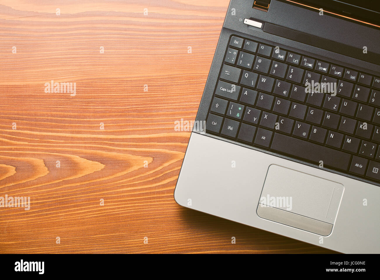 detail of laptop on wooden table Stock Photo - Alamy