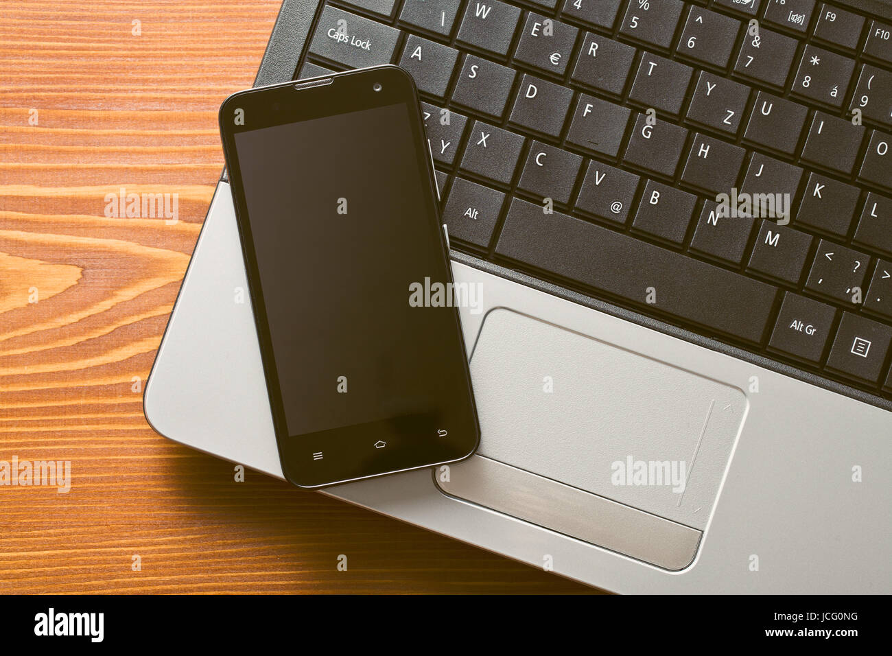laptop and smartphone on office table Stock Photo - Alamy