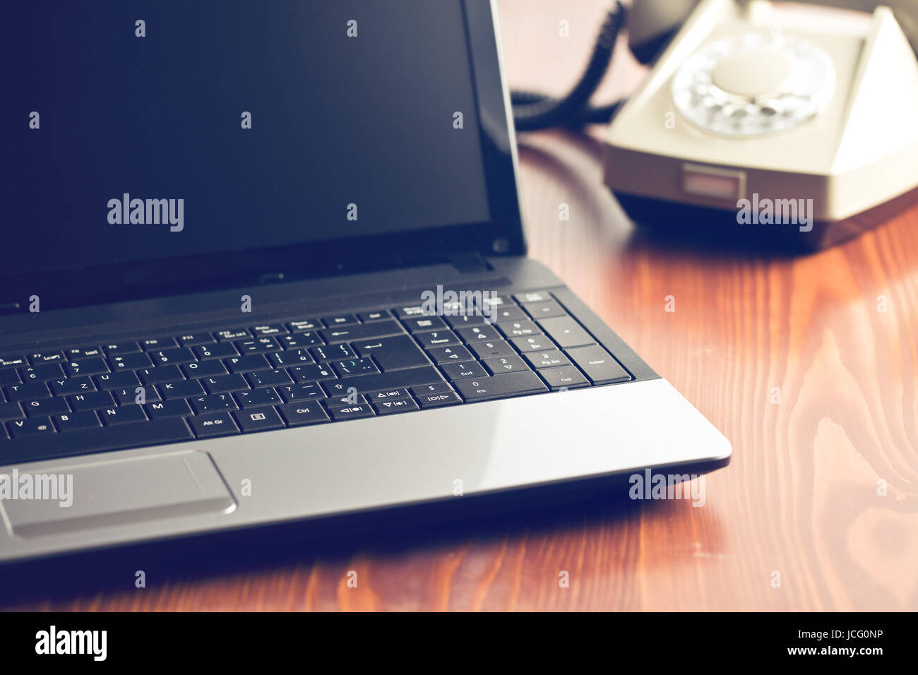 laptop and retro phone on office table Stock Photo - Alamy