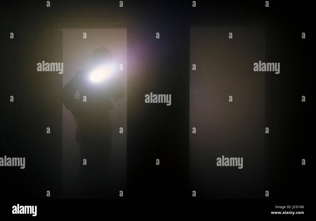 Fireman with a torch in a smoke filled room in a domestic house Stock ...