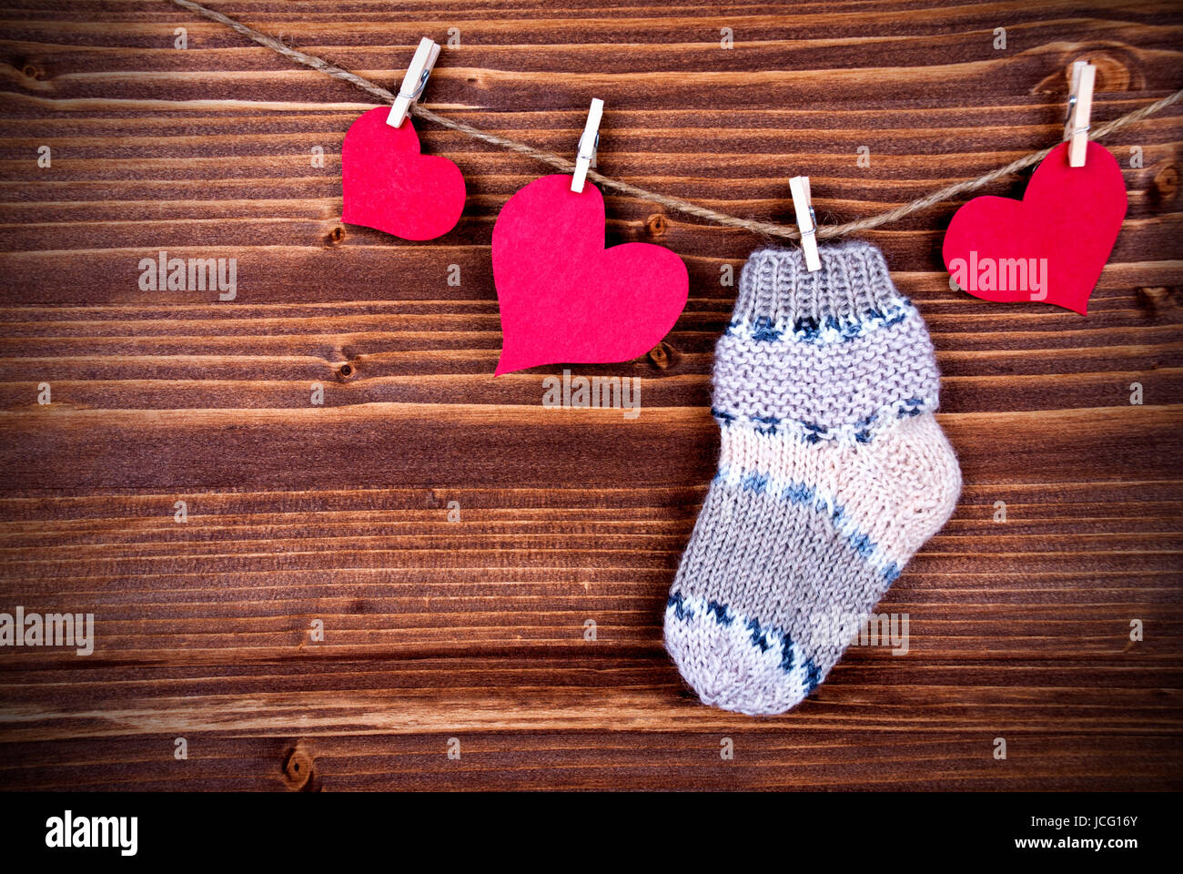 A Baby Stocking Hanging on a Line with Heart, Symbolizing Happiness to ...