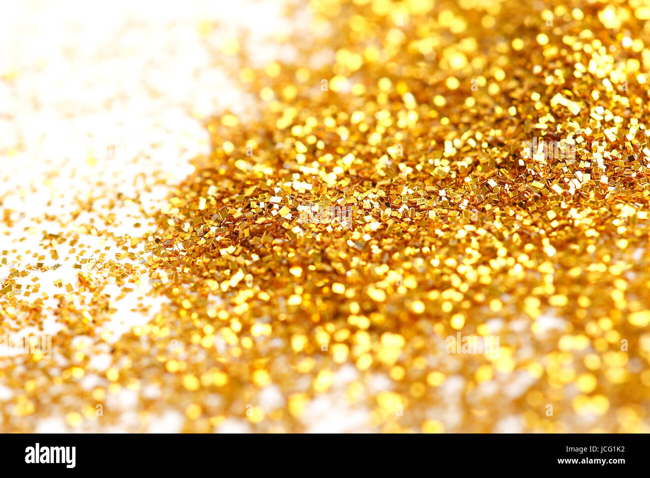 Closeup of golden glitter on white background Stock Photo - Alamy