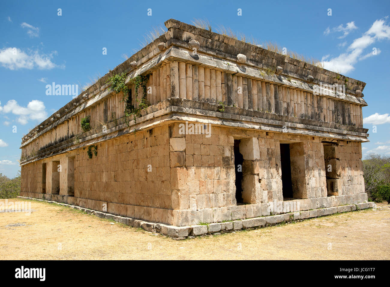 abandoned ancient Mayan stone buildngwith blue sky in the background ...