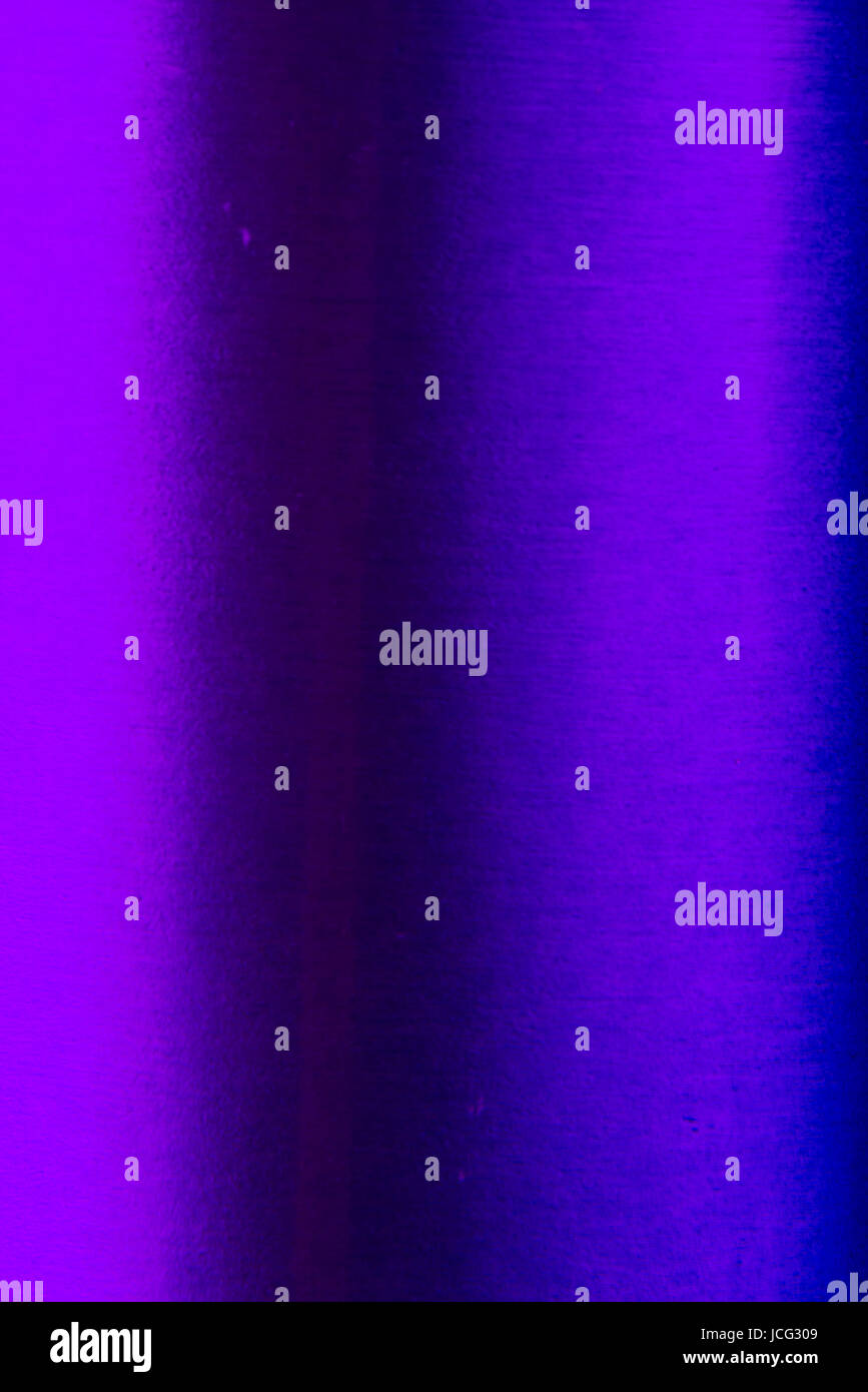 Detailed view of a blue metallic can with light reflections and color ...