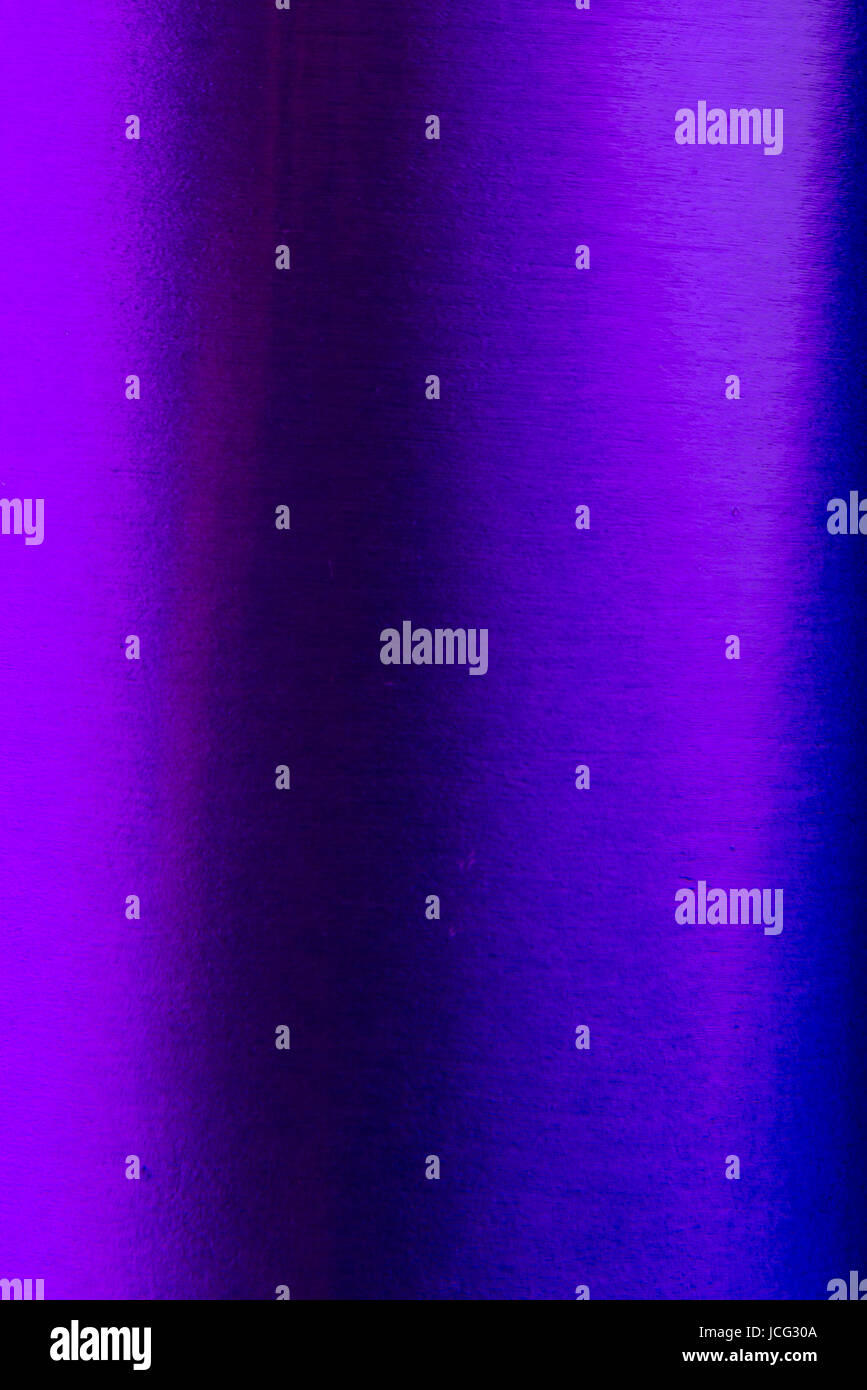 Detailed view of a blue metallic can with light reflections and color ...