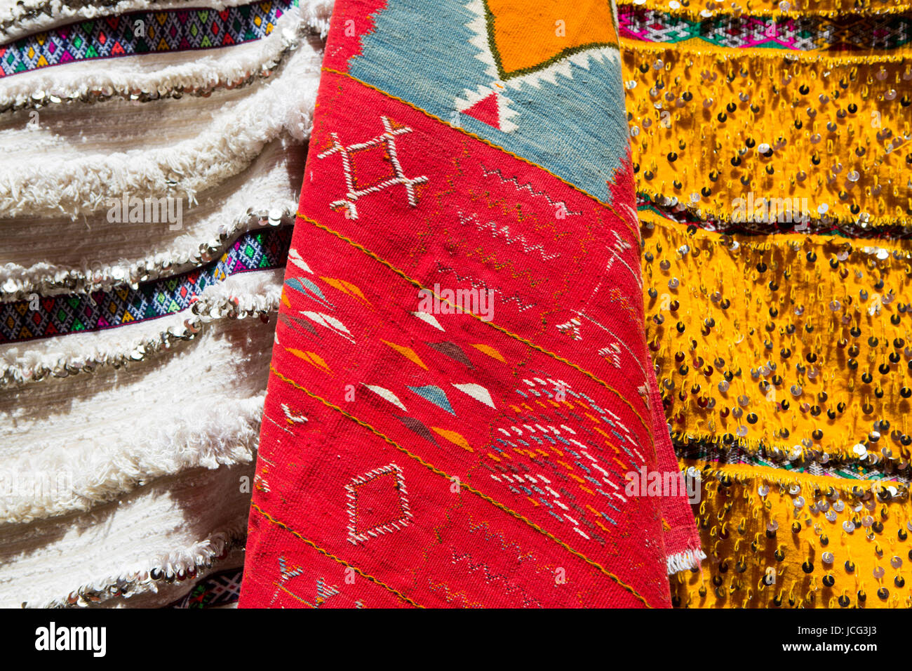 Three colorful moroccan rugs hanging on a wall on the market in ...
