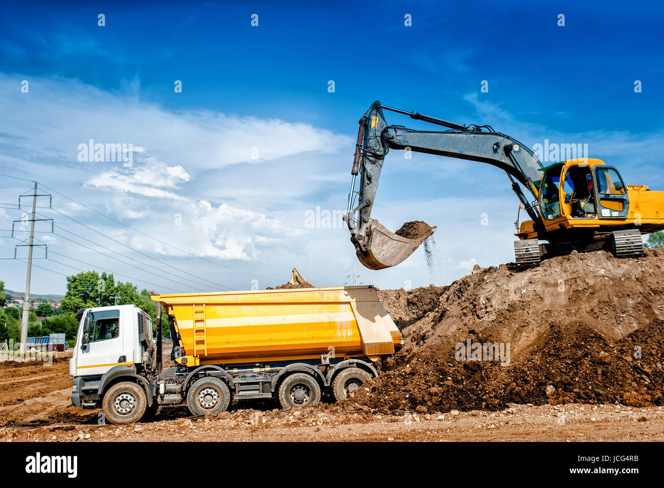 Industrial truck loader excavator and bulldozer moving earth and ...
