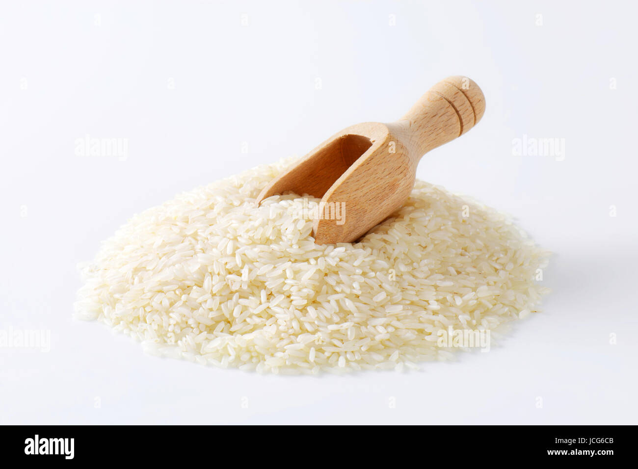 Heap of uncooked white rice Stock Photo - Alamy
