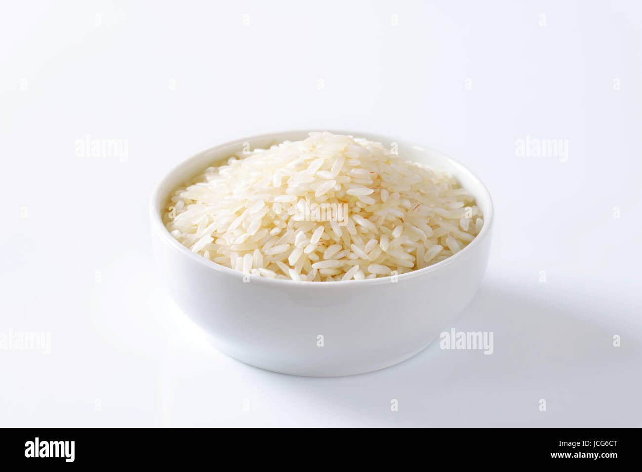 Bowl of uncooked white rice Stock Photo - Alamy