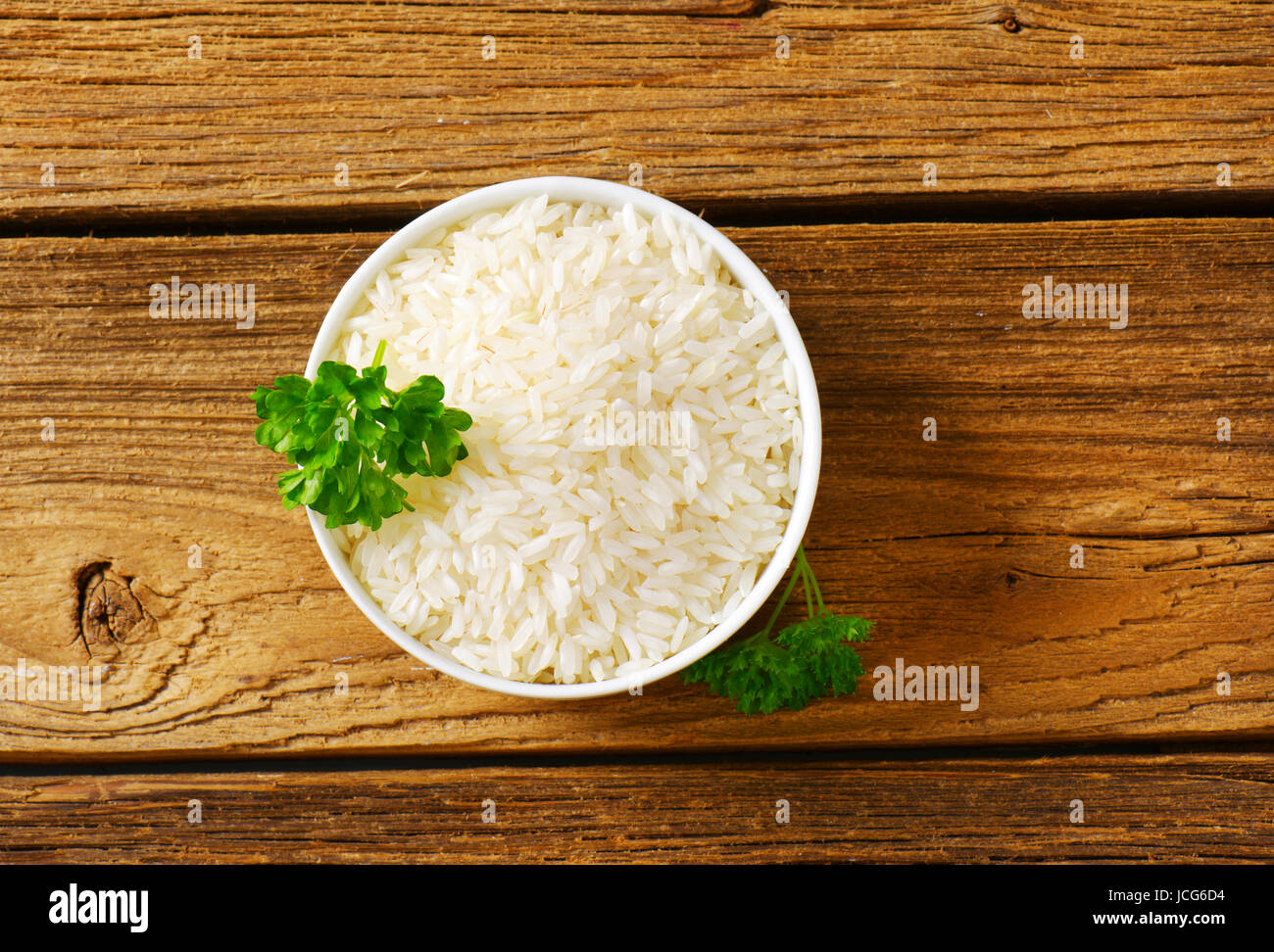 Bowl of uncooked white rice Stock Photo - Alamy
