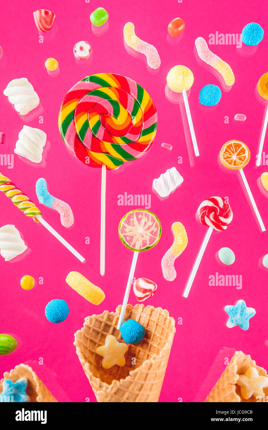 Close-up top view of crispy waffle cones and mix of delicious sweets on ...