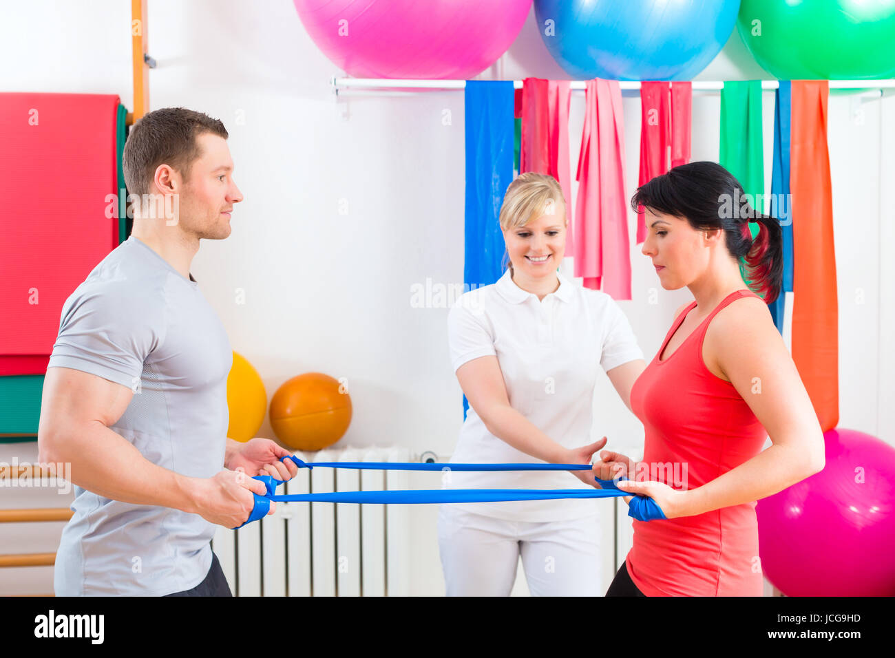 Patients at the physiotherapy doing physical exercises with therapist ...