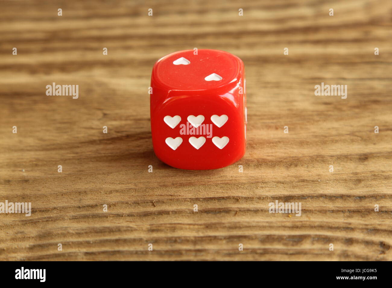 Red dice with hearts instead of numbers on wooden background Stock ...