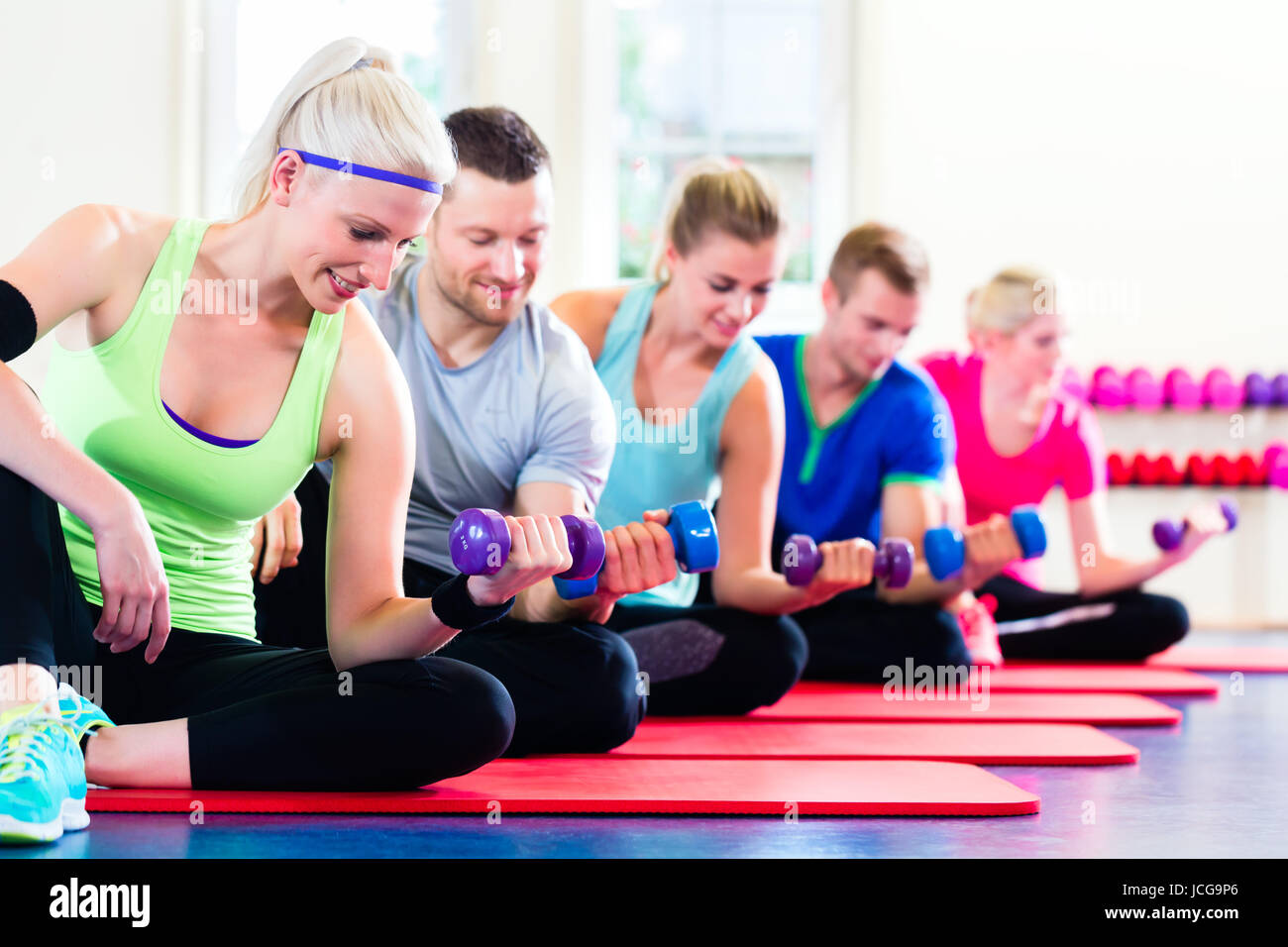 fitness people in gym working out with dumbbells Stock Photo - Alamy