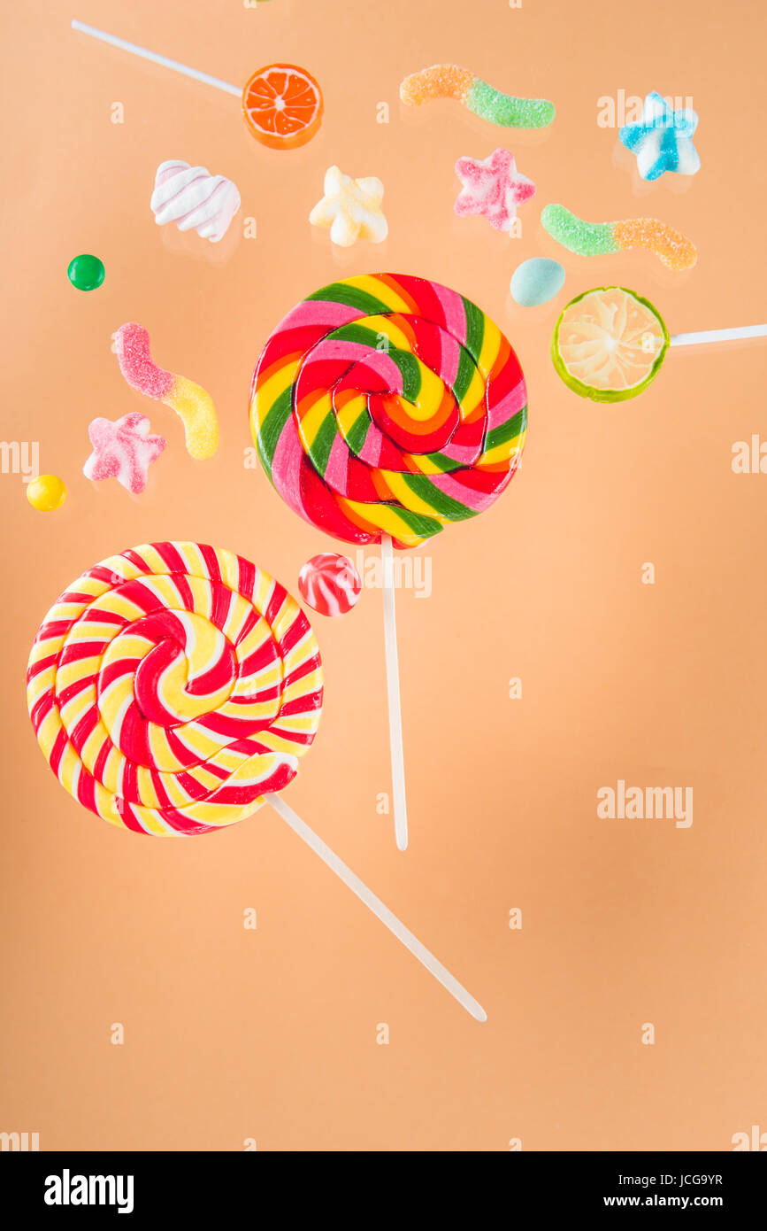different colorful delicious jelly candies and lollipops on beige Stock ...
