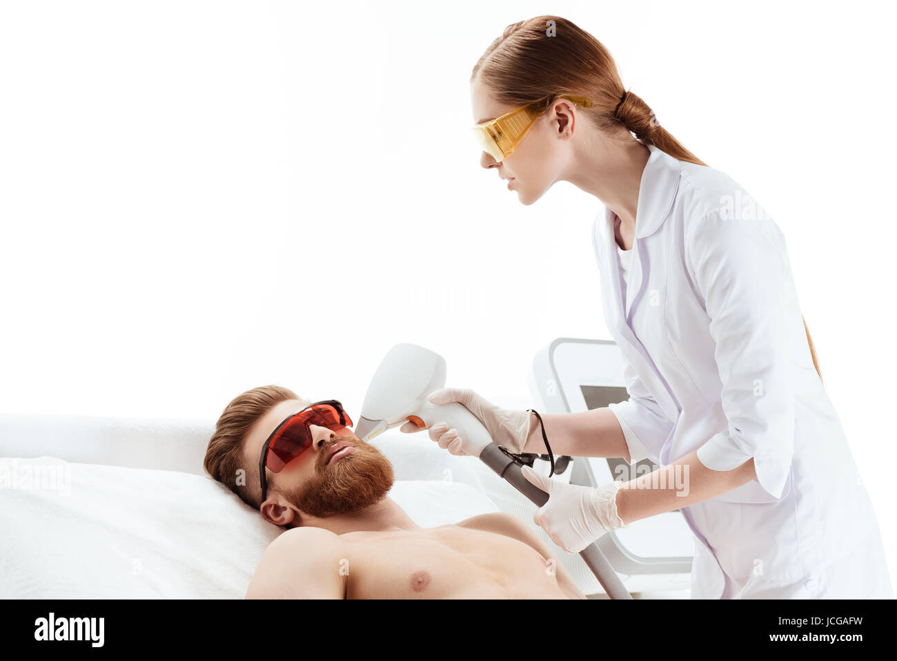 young man receiving laser skin care on face isolated on white. healthy ...