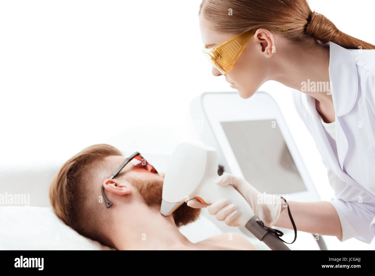 young man receiving laser skin care on face isolated on white. healthy ...