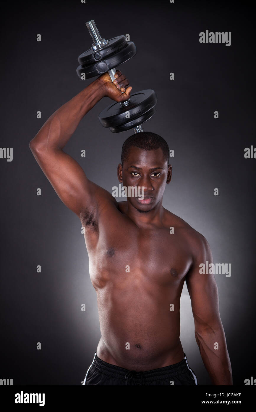 Portrait Of A Young African Man Exercising With Dumbbells Stock Photo ...