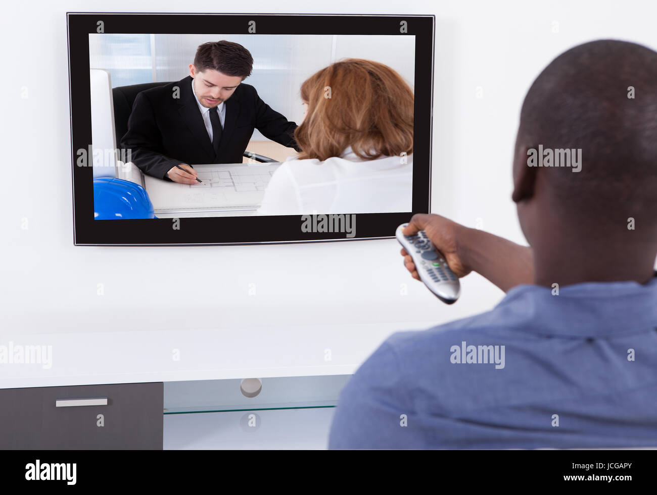 Rear View Of African Man With Remote In Front Of Television Stock Photo ...