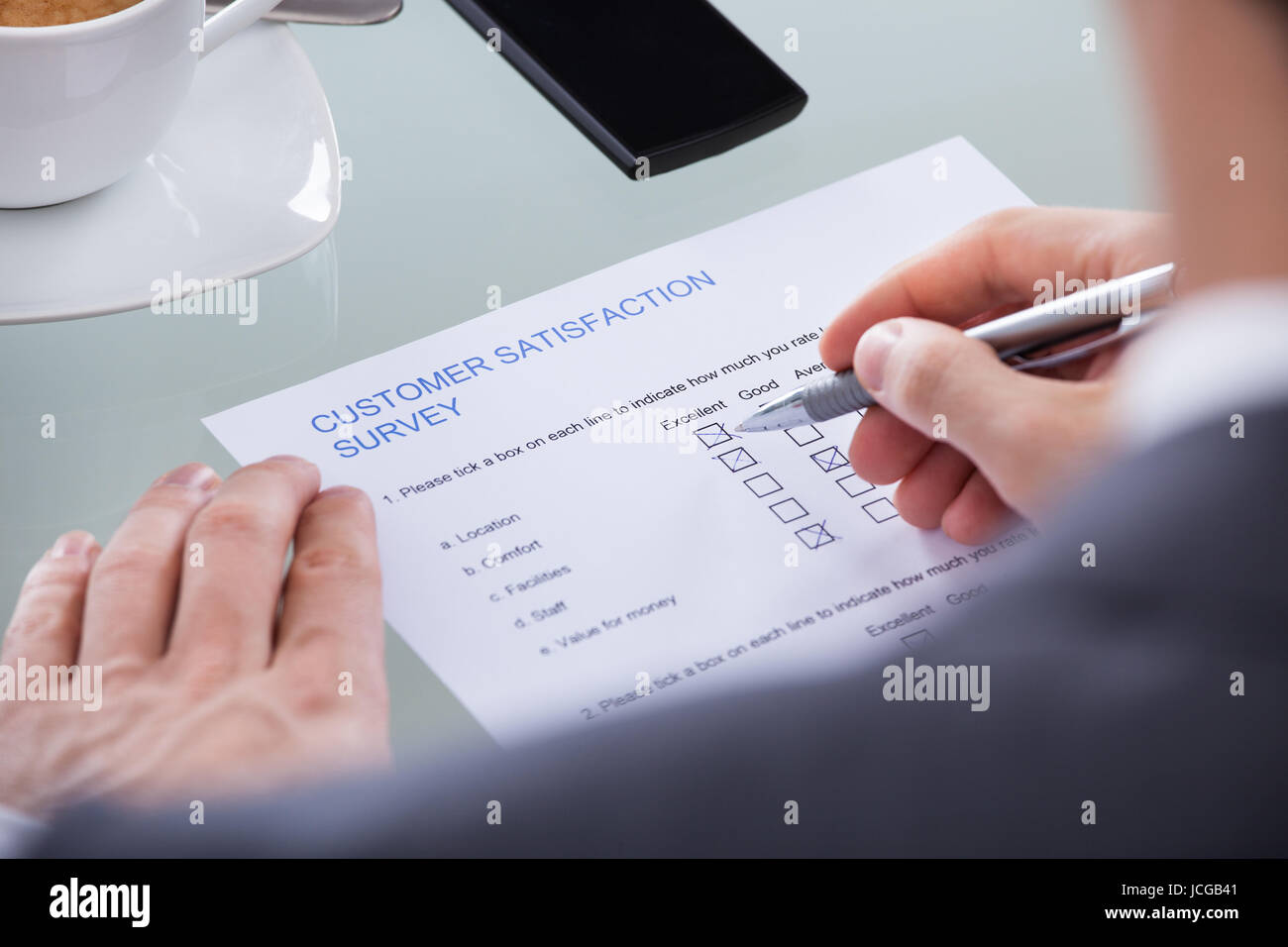 Close-up Of Businessperson Filling Survey Form With Pen Stock Photo - Alamy