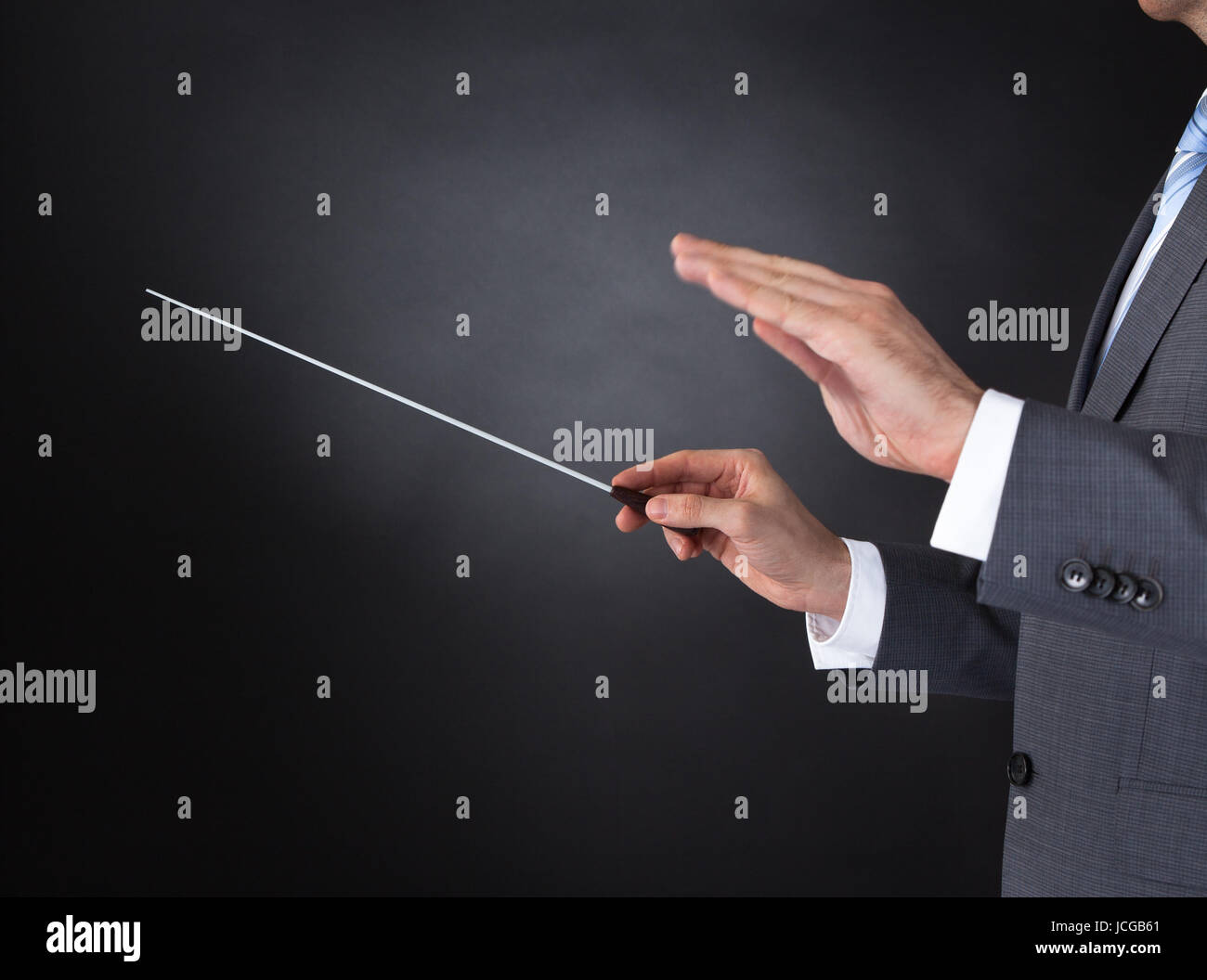 Close-up Of Orchestra Conductor Hands Holding Baton Over Black ...