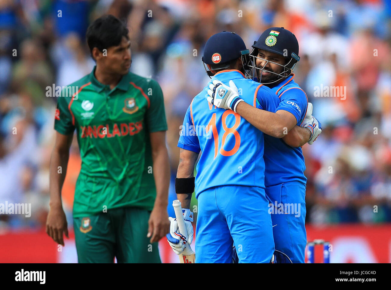 India's Rohit Sharma is congratulated on reaching his century by team ...