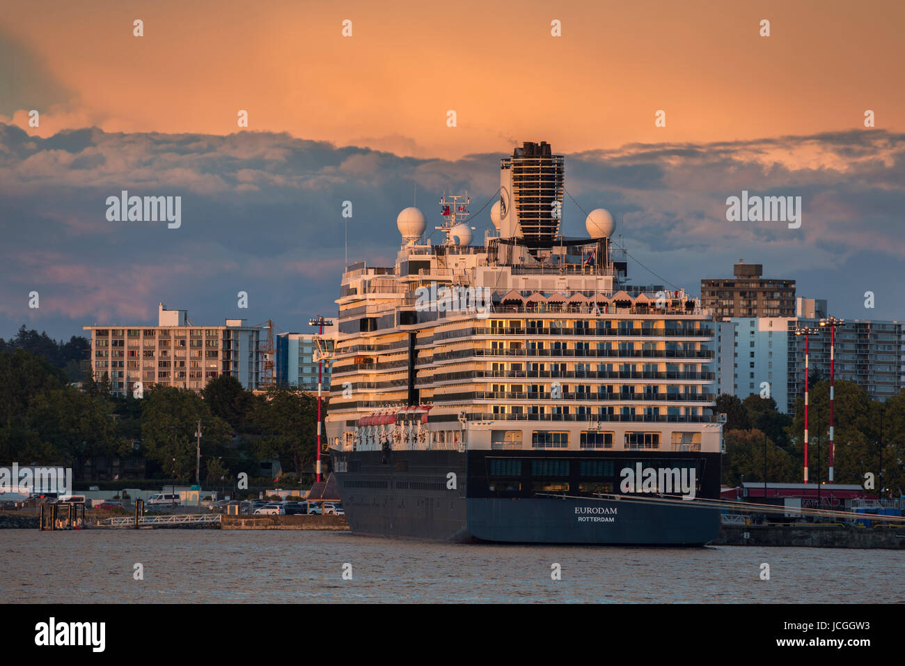 Holland American cruise ship Eurodam docked at port of Victoria at dusk ...