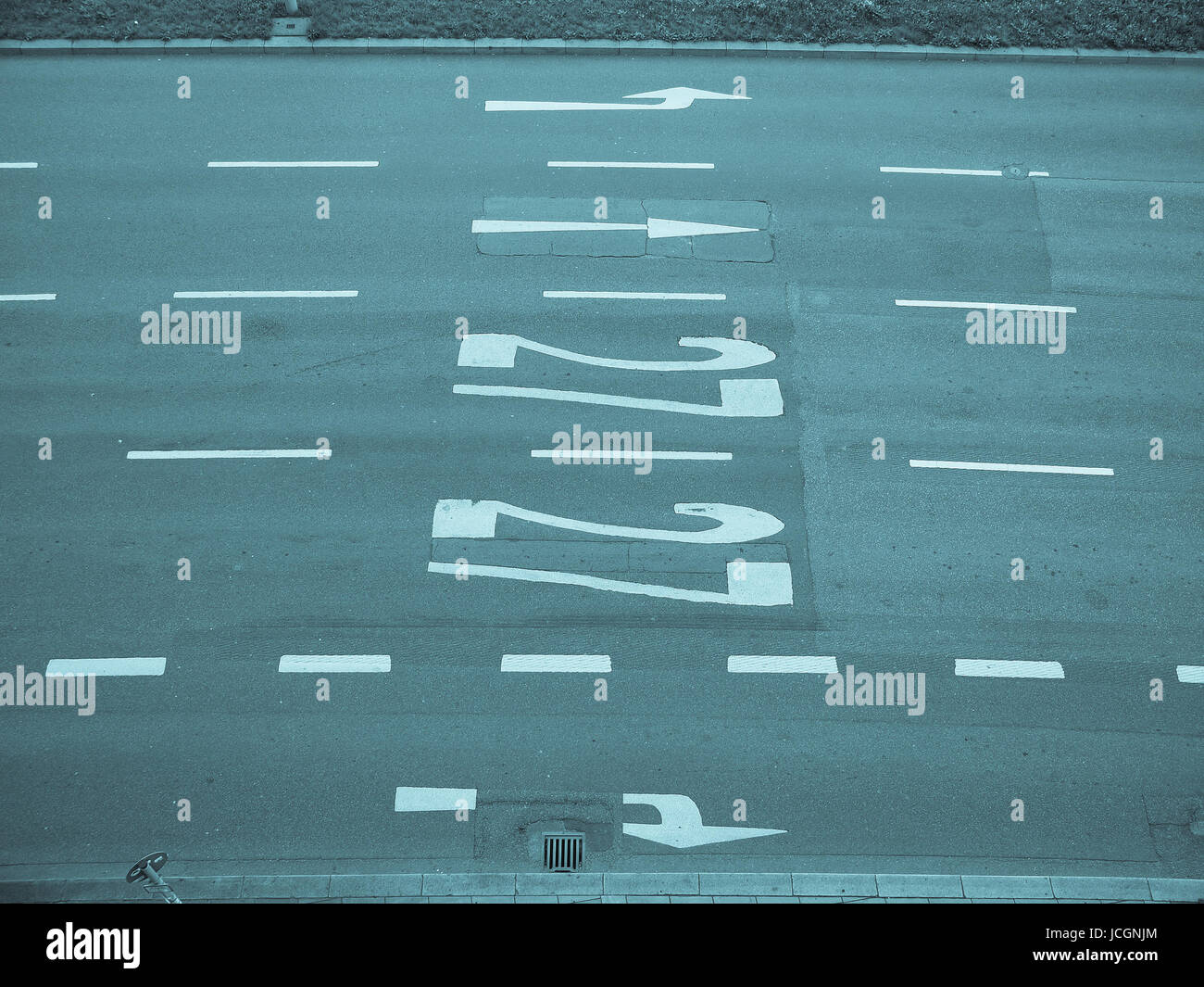 Street lane sign painted in white on black asphalt - cool cyanotype ...