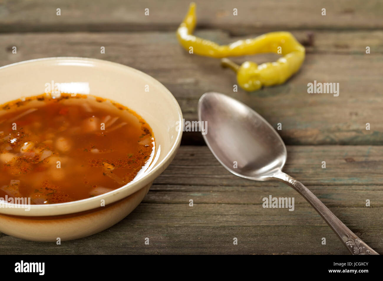 Traditional national Romanian soup borscht with beans on the old wooden ...
