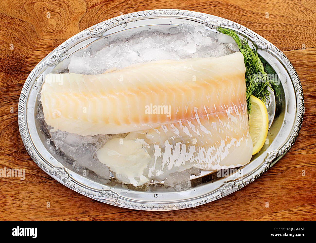 Raw cod fish fillet on ice Stock Photo - Alamy