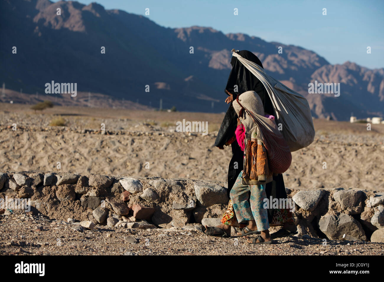 Bedouin woman walking with her kid. Nuweiba. Egypt Stock Photo - Alamy