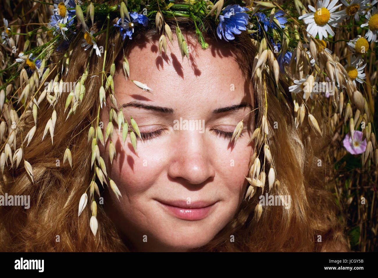 Lady in flower wreath in summer time Stock Photo - Alamy
