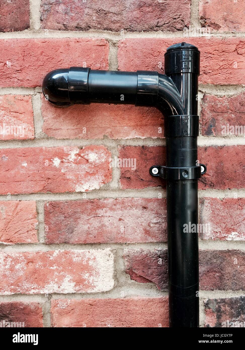 Black sewage pipe outdoor on old brick wall Stock Photo - Alamy