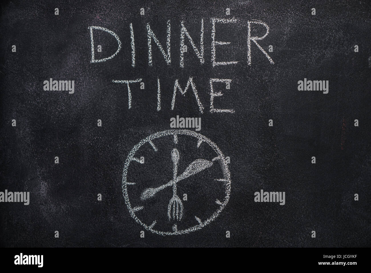Dinner time text with clock drawn with white chalk on blackboard Stock ...