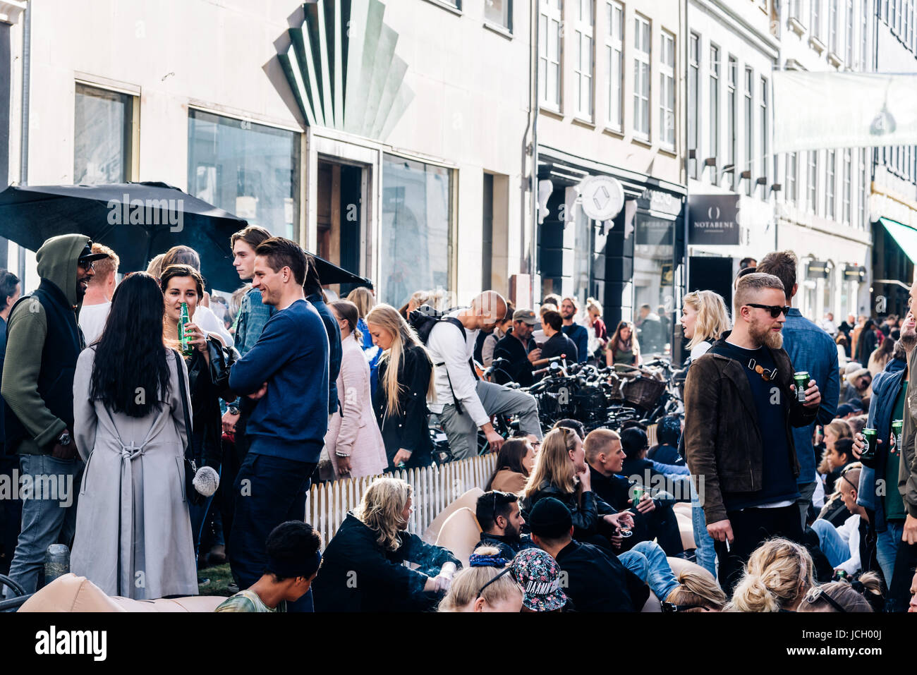 Copenhagen, Denmark - August 11, 2016. Crowd of young people sitting ...