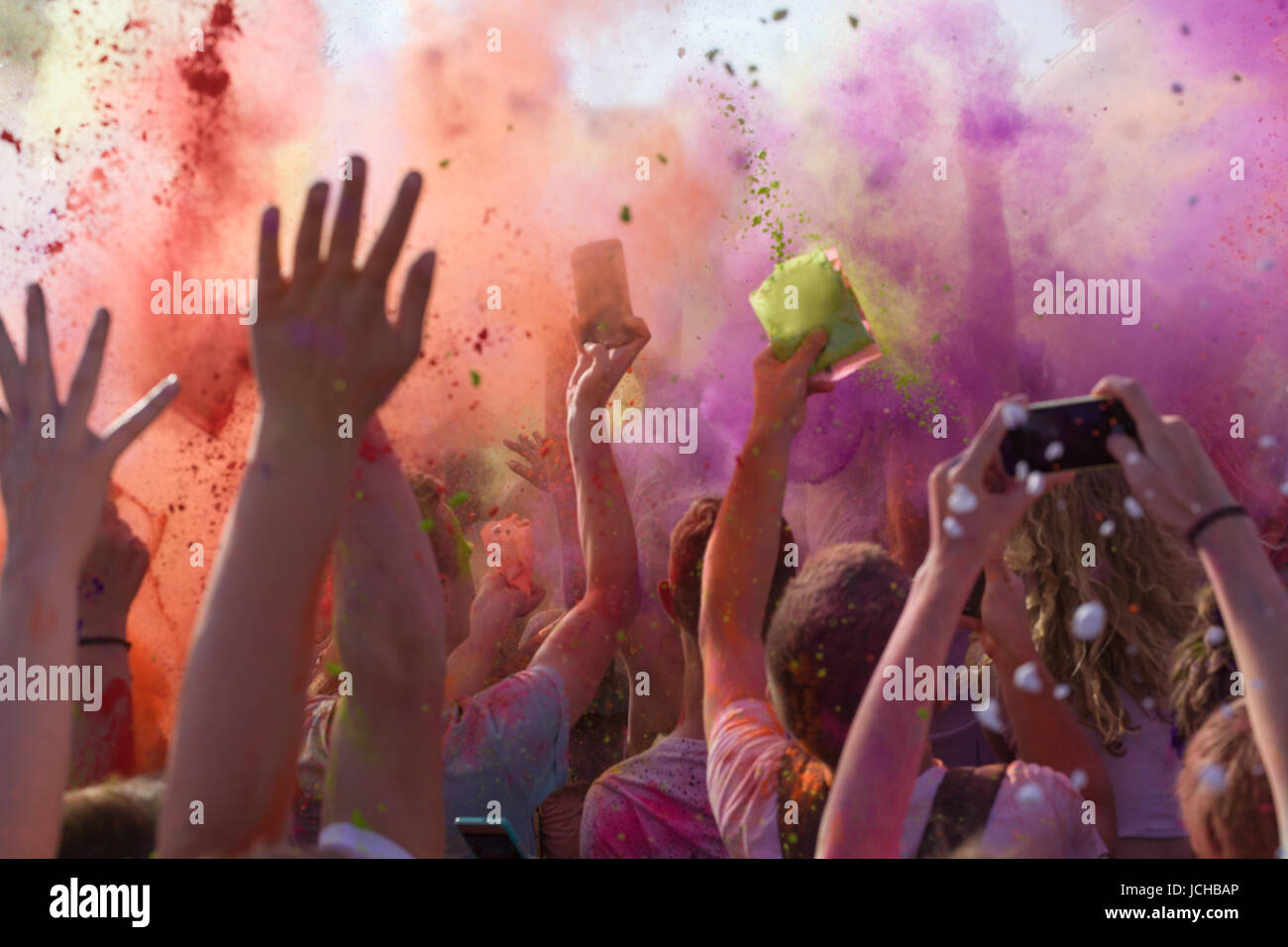 Festival of Colours - holi > Mass event, colored powder. Raised hands ...