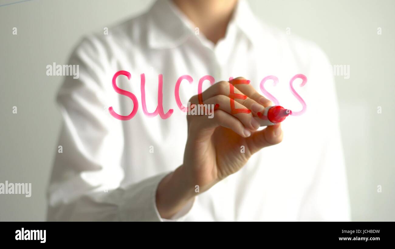 Woman writing Success on transparent screen. Businesswoman write on ...