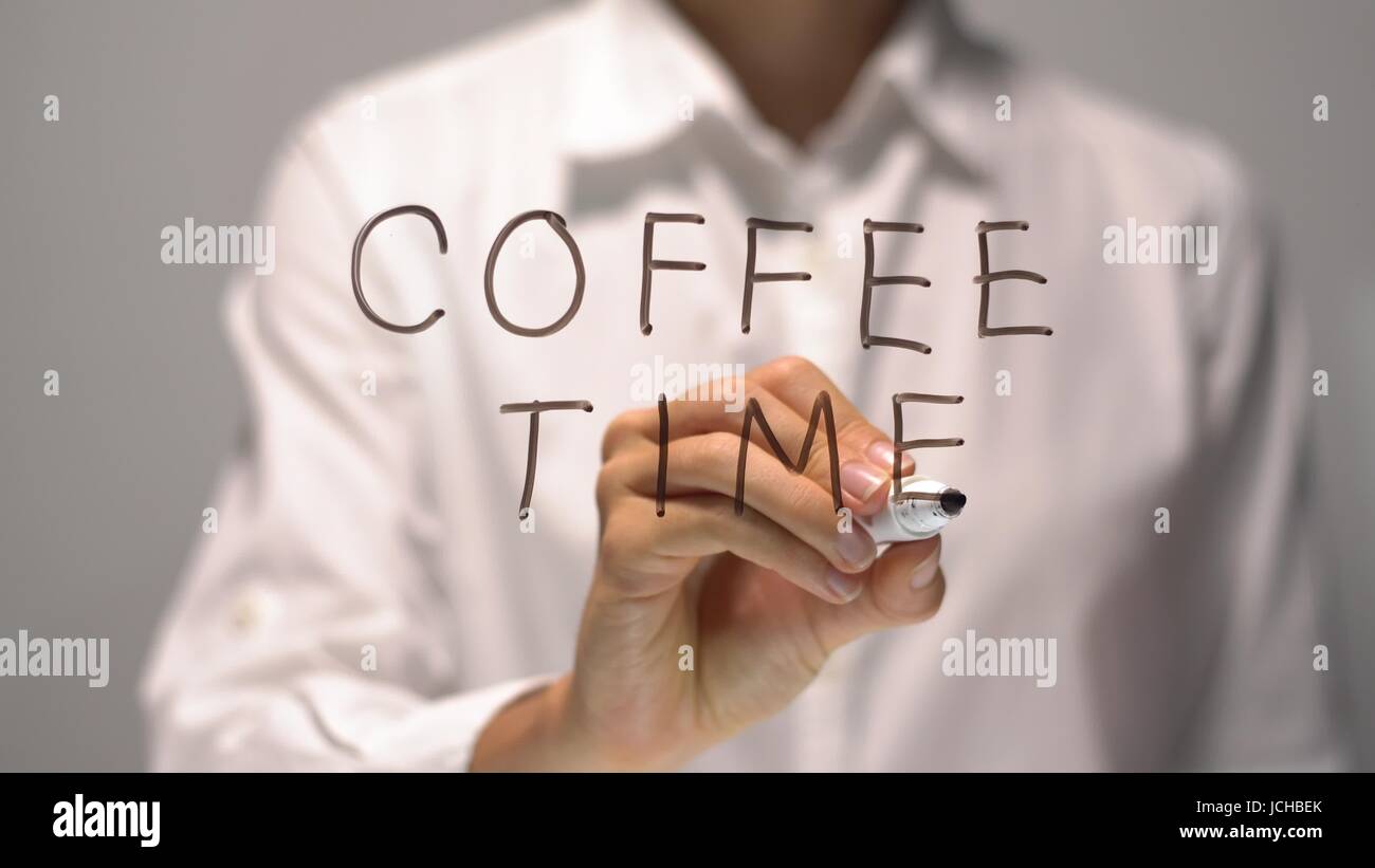 Woman writing Coffee Time on transparent screen. Businesswoman write on ...