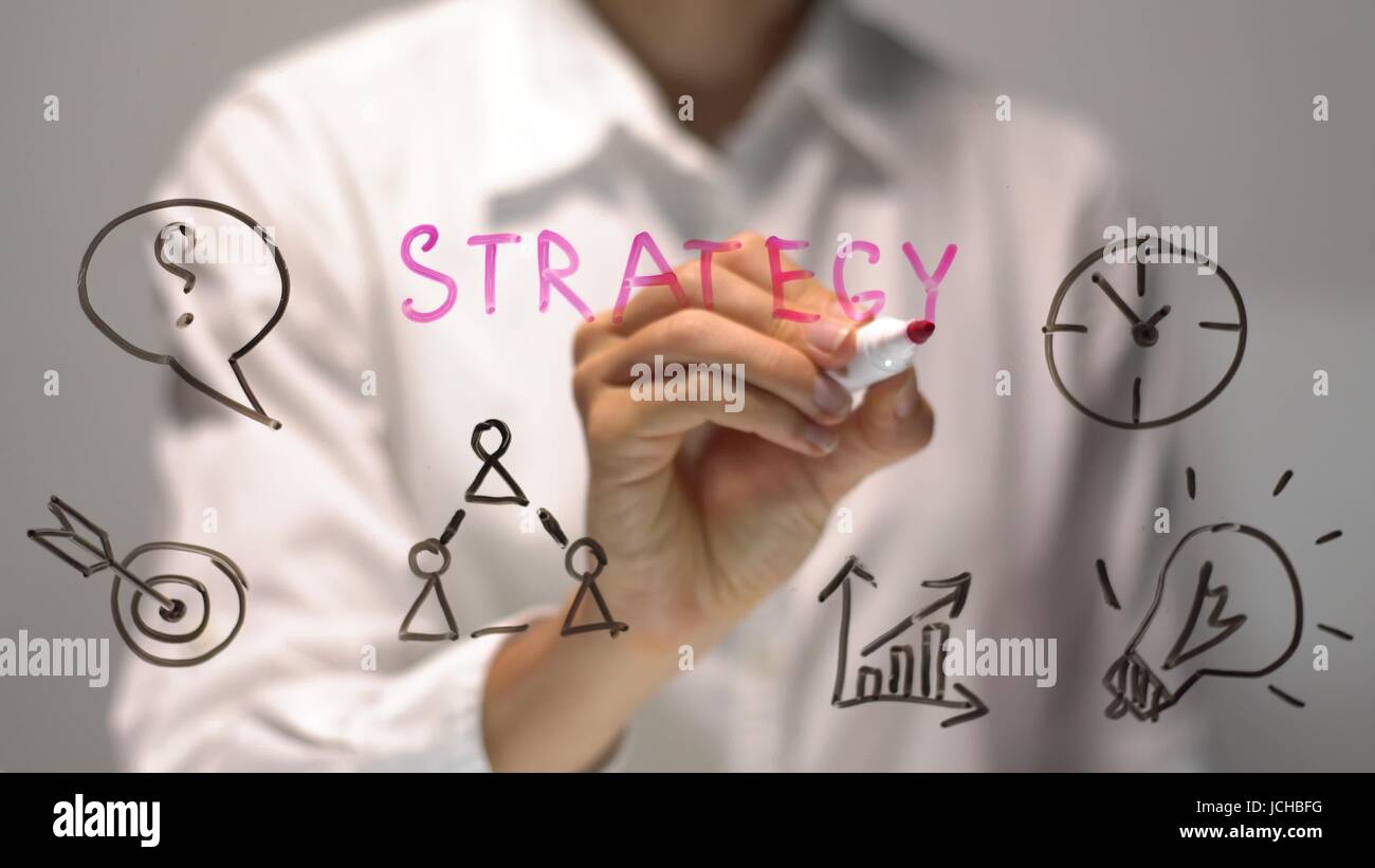 Woman writing Strategy on transparent screen. Businesswoman write on ...