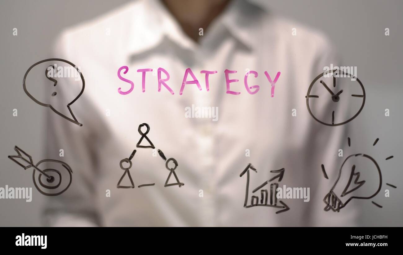 Woman wrote Strategy on transparent screen. Businesswoman write on ...