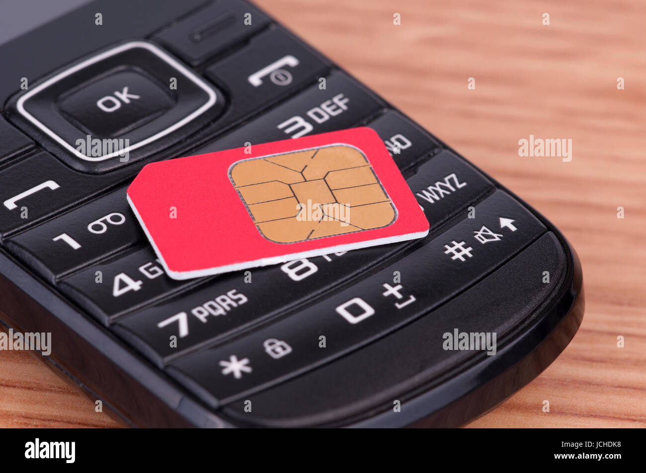SIM Card over the Phone on the table Stock Photo - Alamy