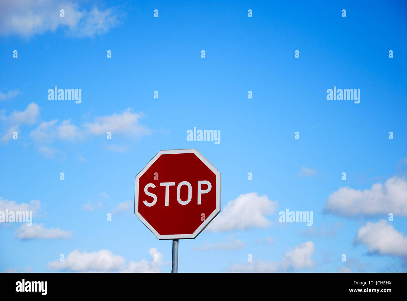 Stop roadsign at blue sky with summer clouds Stock Photo - Alamy