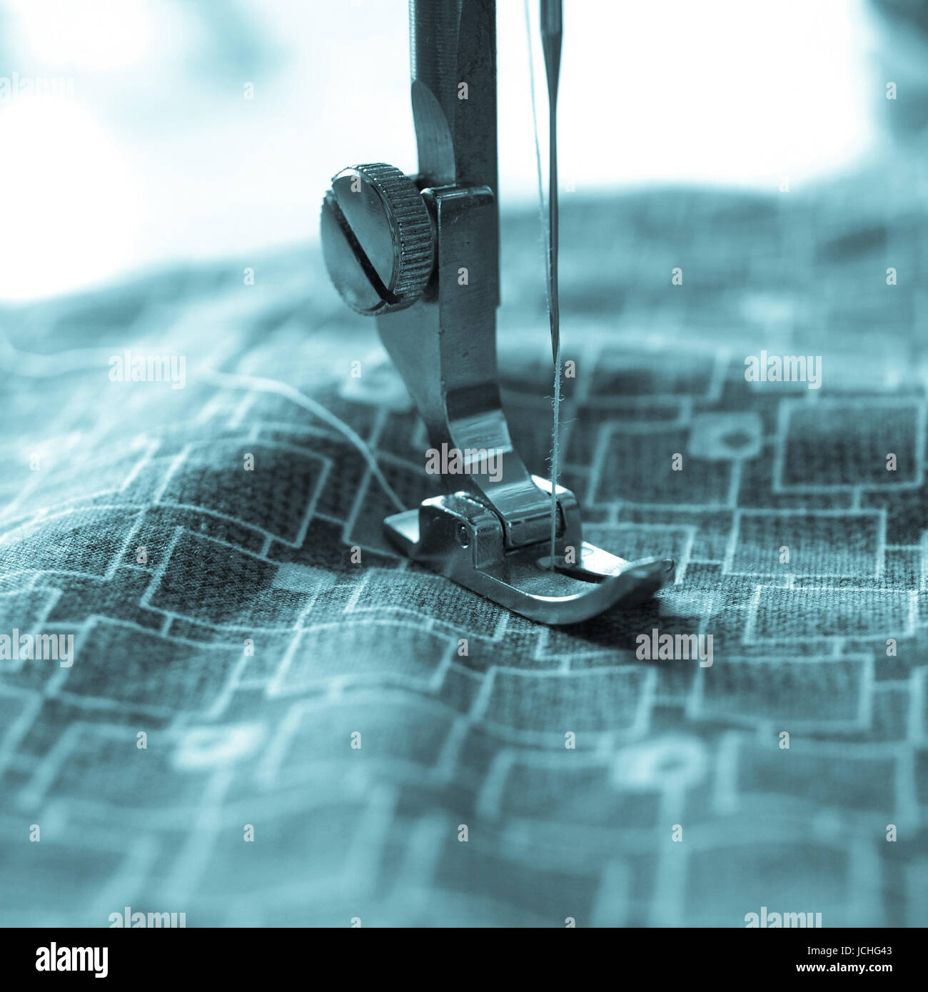 Detail of a needle in a sewing machine - cool cyanotype Stock Photo - Alamy