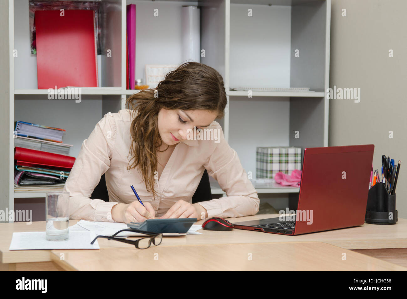 Young girl working at the desk in the office Stock Photo - Alamy