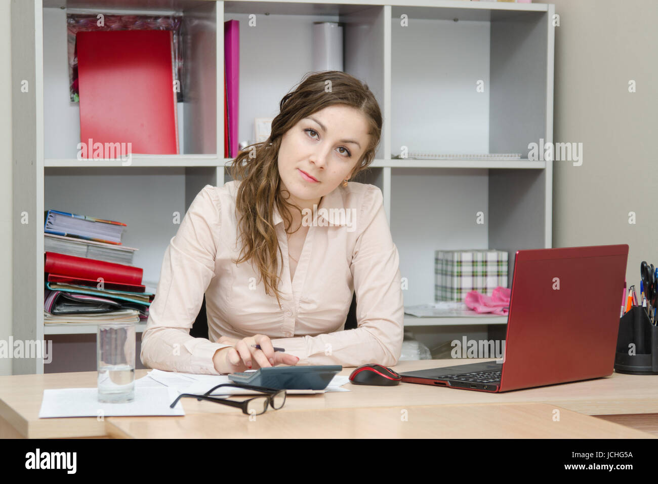 Young girl working at the desk in the office Stock Photo - Alamy